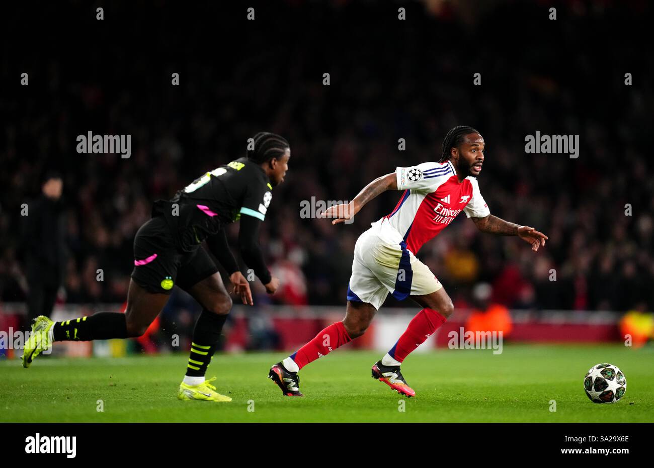 Arsenal's Raheem Sterling (right) and PSV Eindhoven's Tyrell Malacia ...