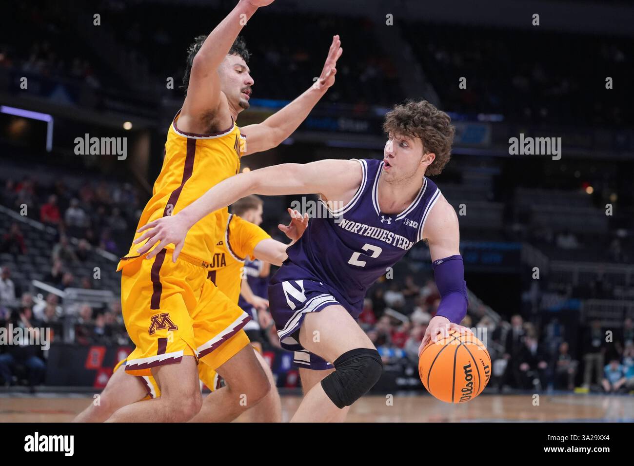 Northwestern forward Nick Martinelli (2) drives on Minnesota forward Dawson Garcia (3) during ...
