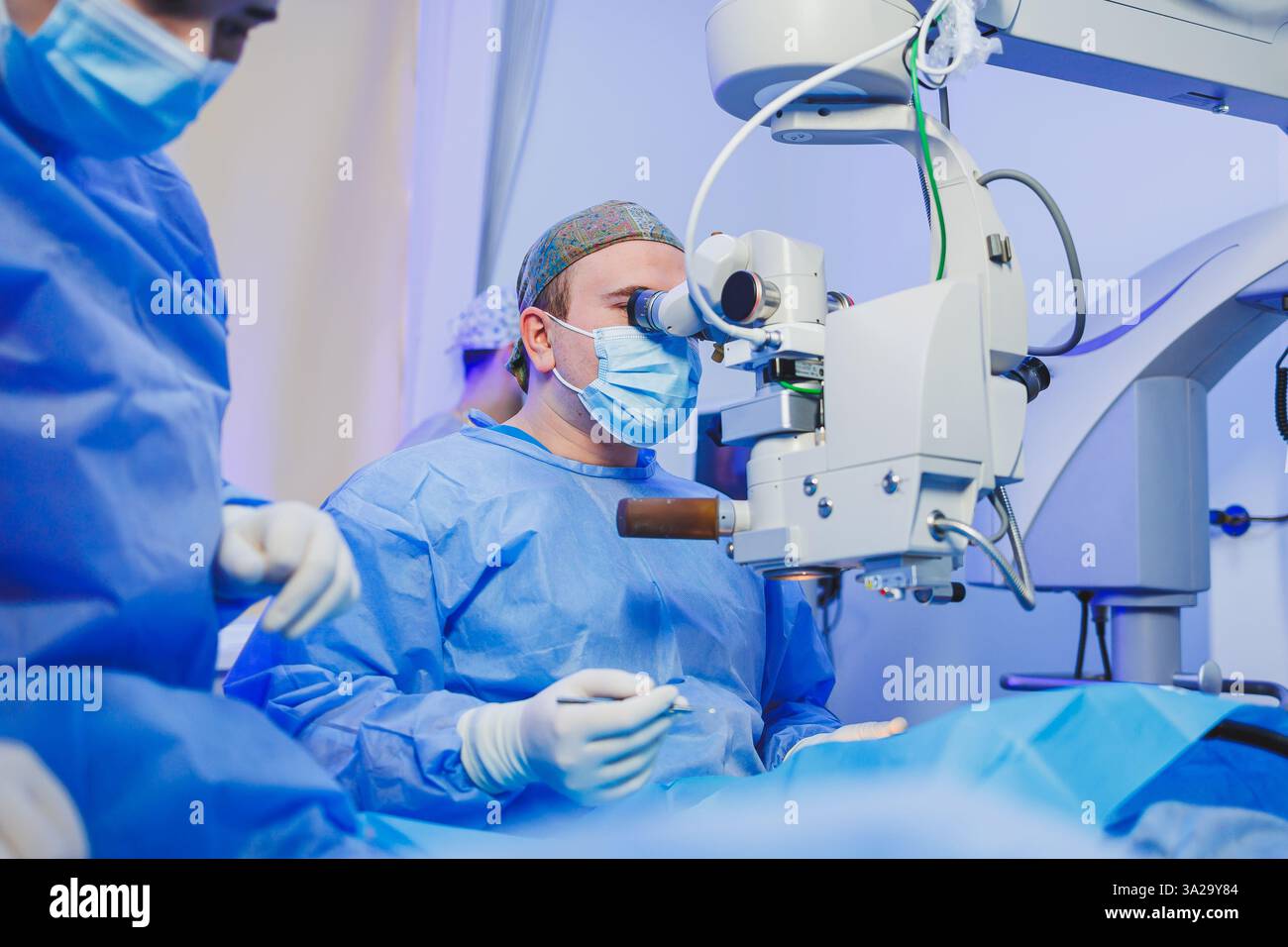Man under a surgical microscope for vision correction. Eye surgery. A ...