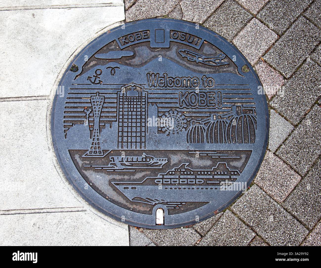 Kobe Osui manhole cover in a road in Kobe City, Japan. Many cities in ...