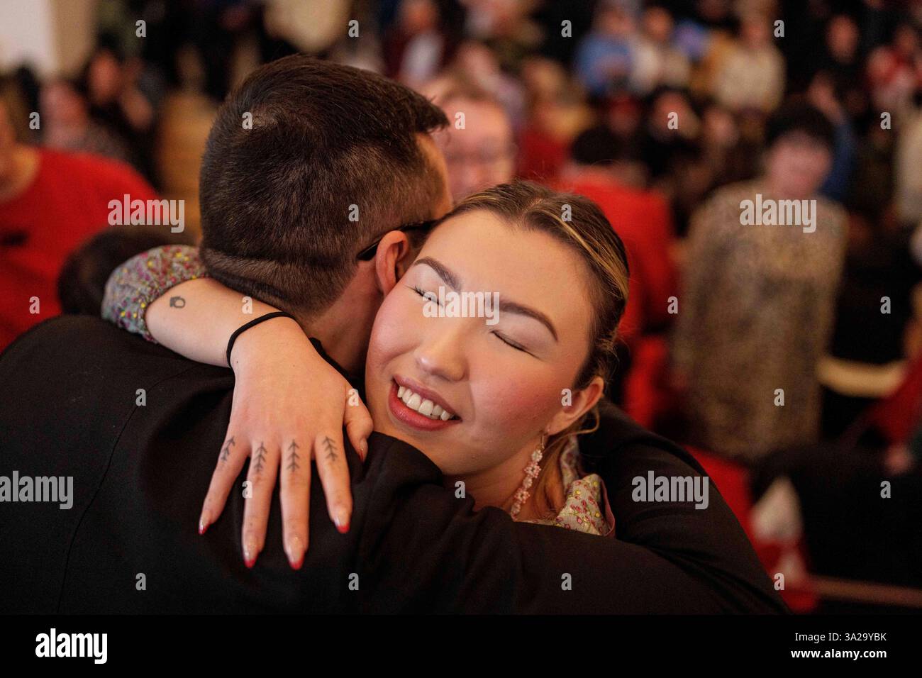 Nivi Rosing, political candidate for the Greenland parliament, hugs his ...