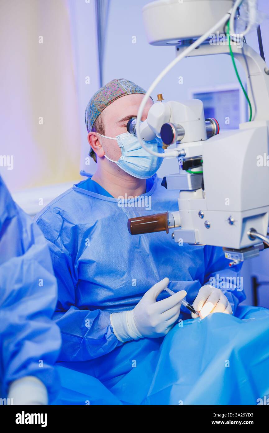 Man under a surgical microscope for vision correction. Eye surgery. A ...