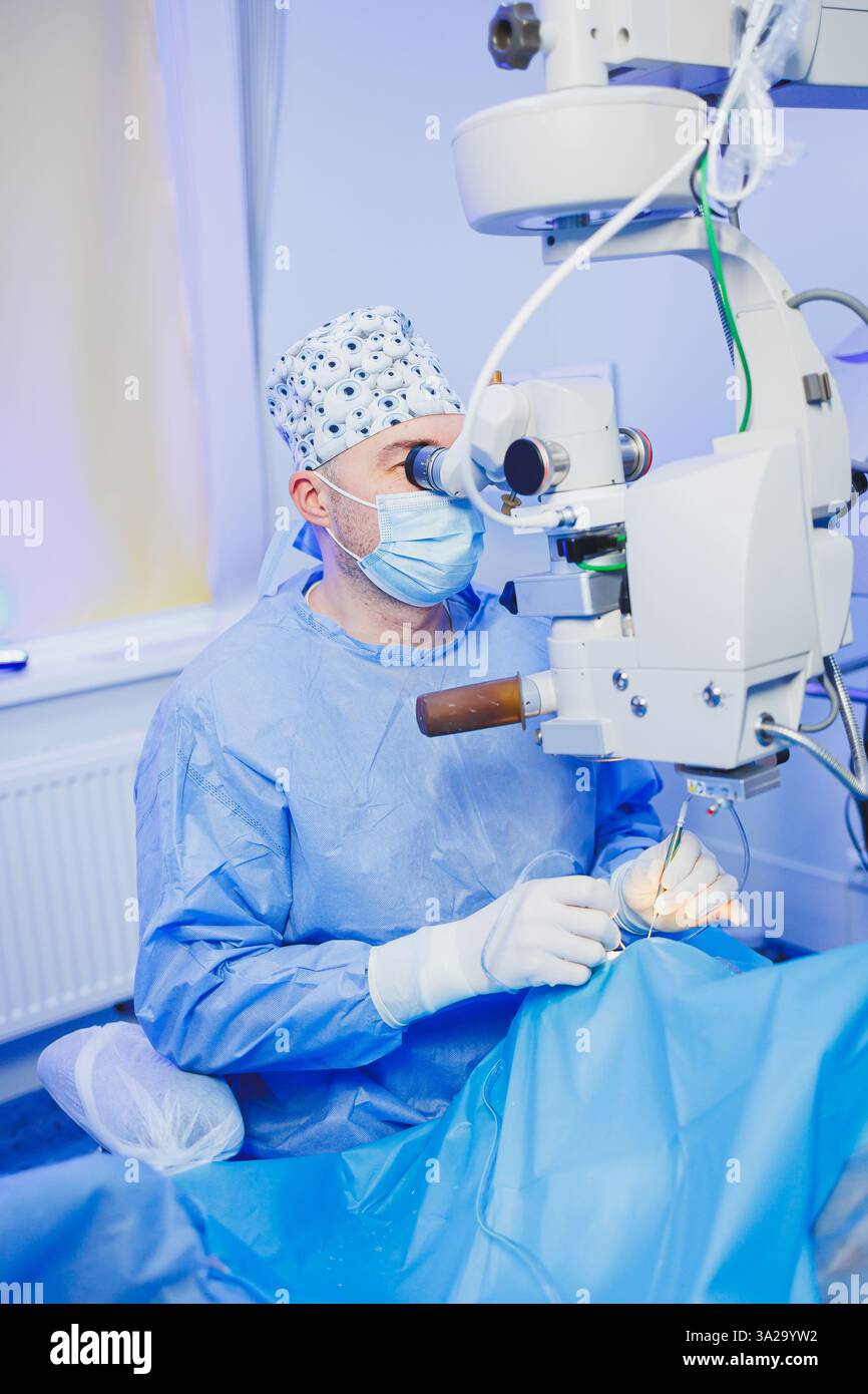 Man under a surgical microscope for vision correction. Eye surgery. A ...