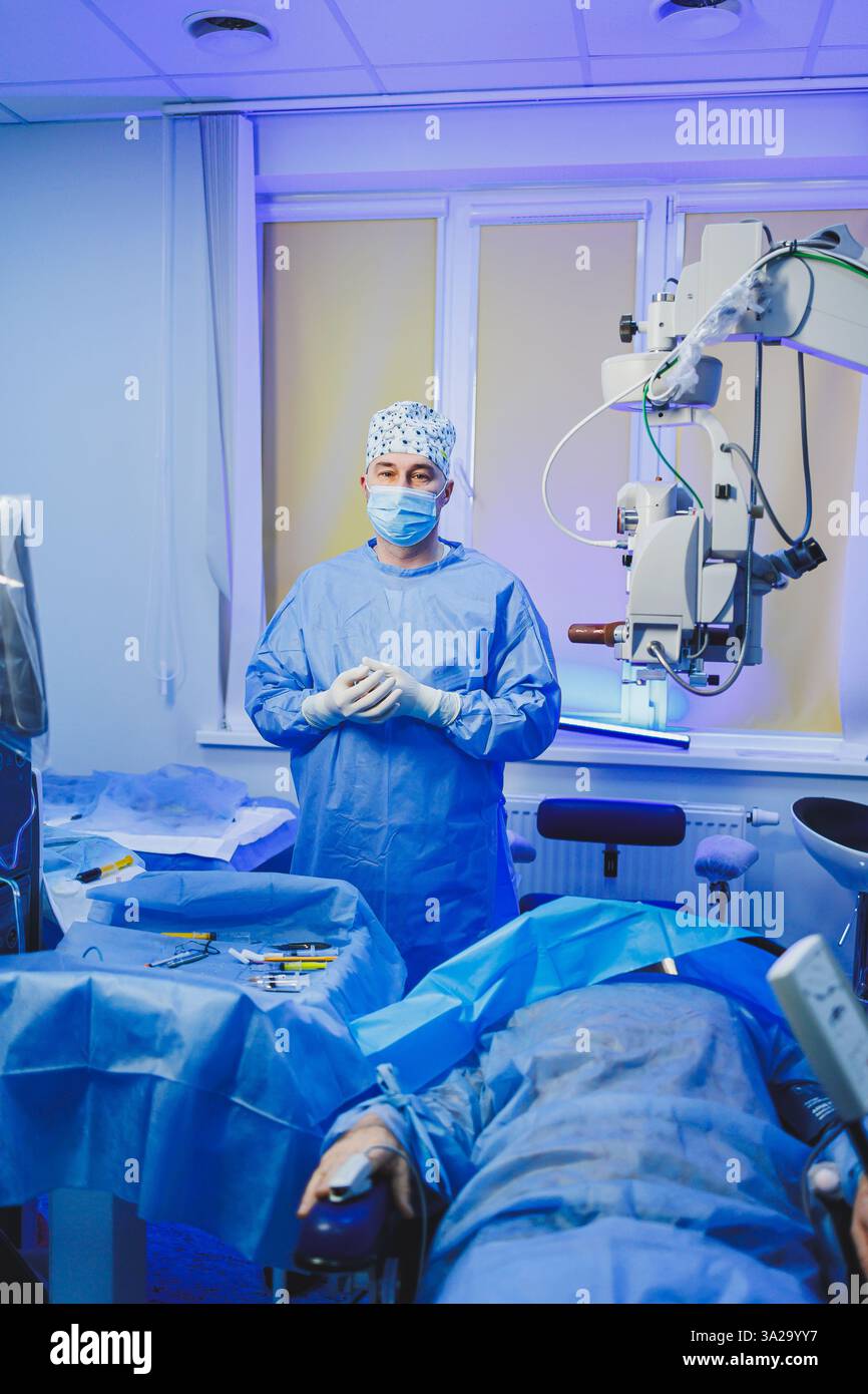 A doctor in a surgical suit is standing in the operating room. A doctor ...