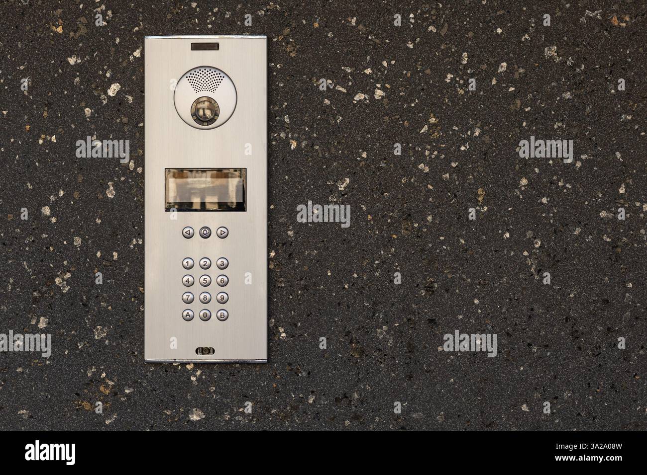 Modern Intercom System With Numeric Keypad Speaker And Camera Installed On Dark Textured Stone