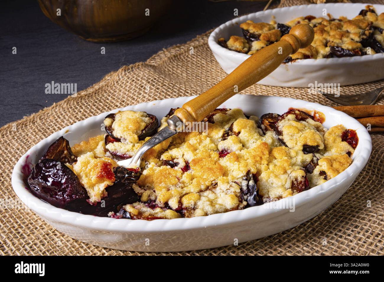 Cinnamon plums with crumble Stock Photo - Alamy