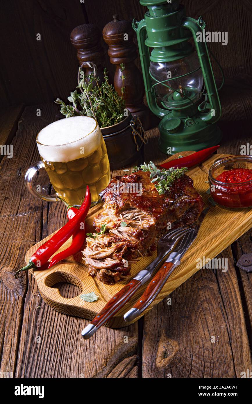 Pork with beer sauce pulled from the oven Stock Photo - Alamy