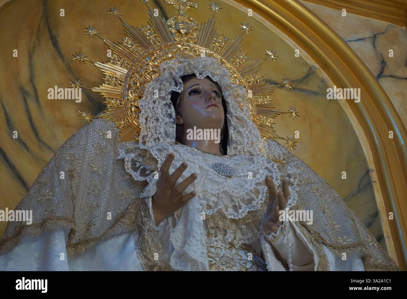 Close up of a statue of Holy Mother Mary with a golden crown halo ...