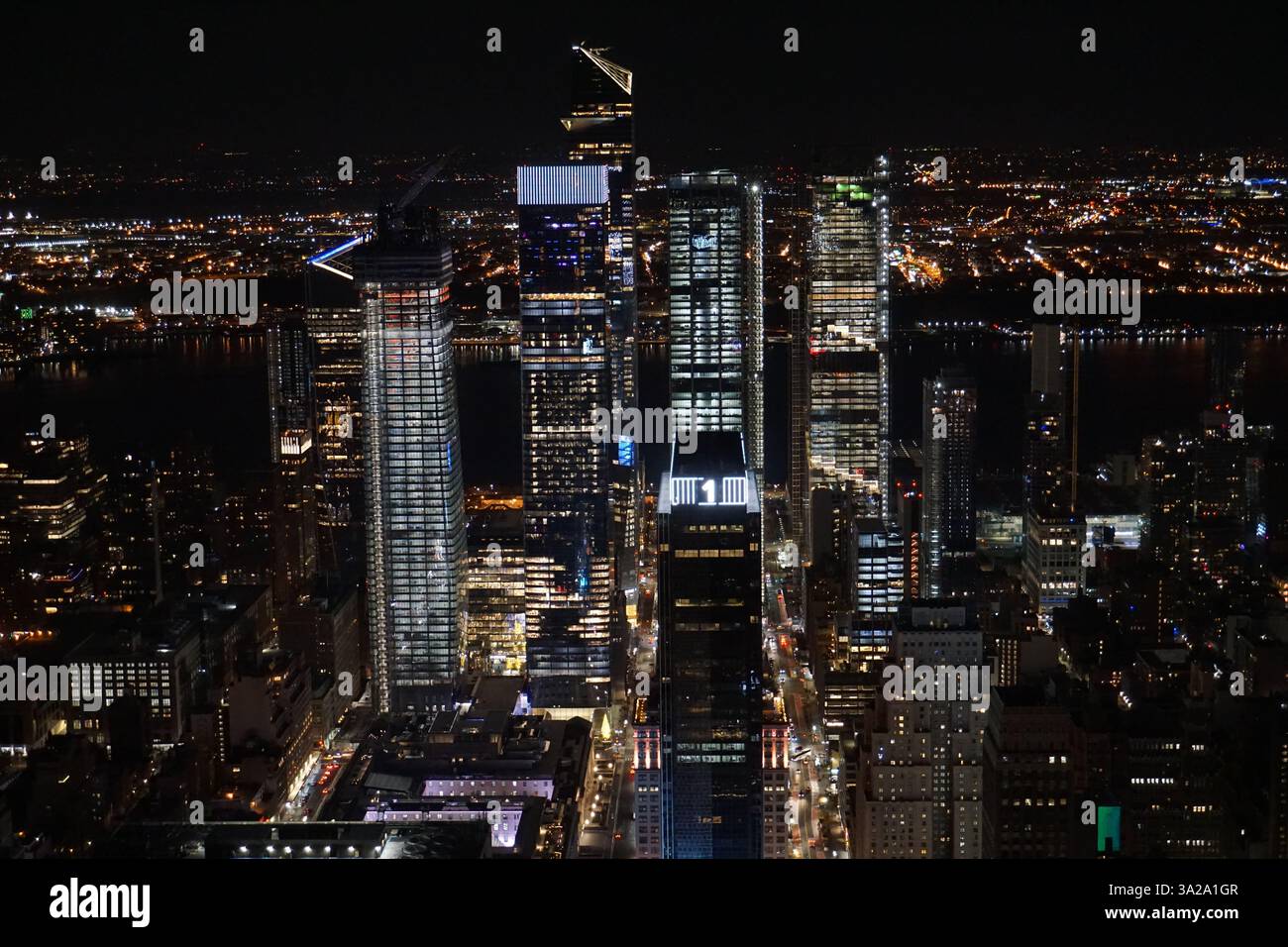 Aerial night time panorama: Bright city lights illuminate the ...