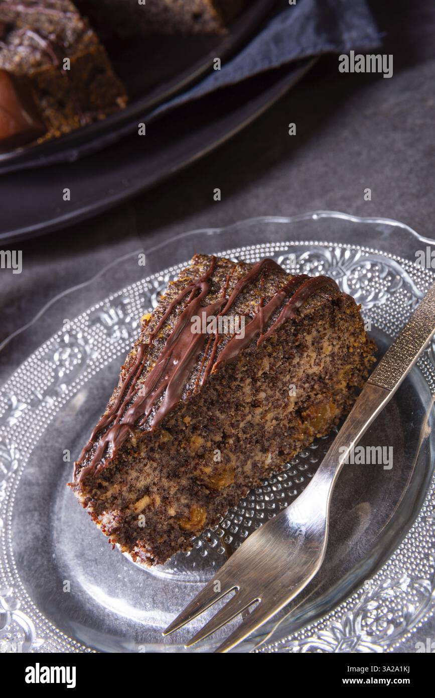 Juicy poppy seed cake with apples and chocolate icing Stock Photo - Alamy