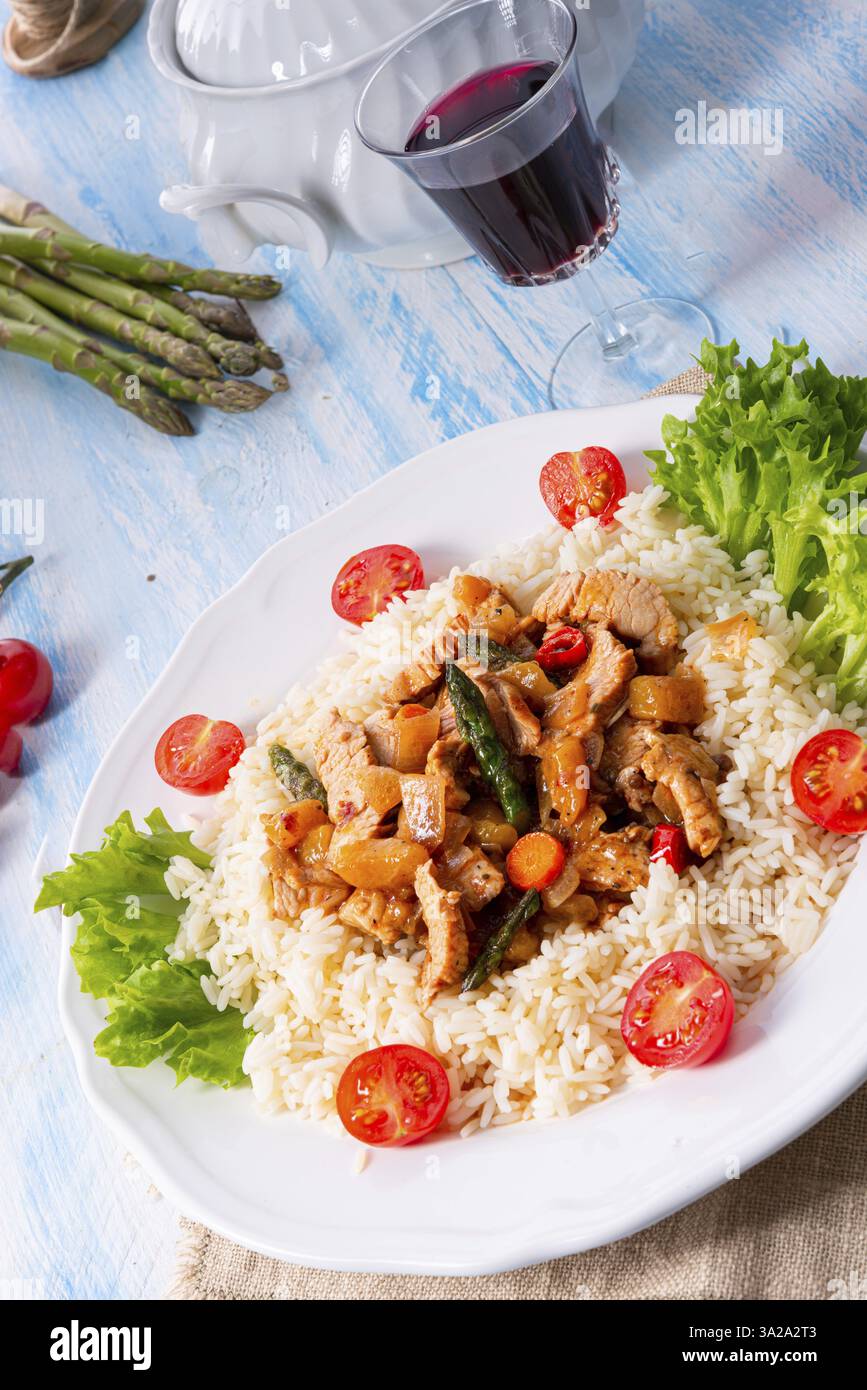 Turkey fricassee on rice with asparagus and peppers Stock Photo - Alamy