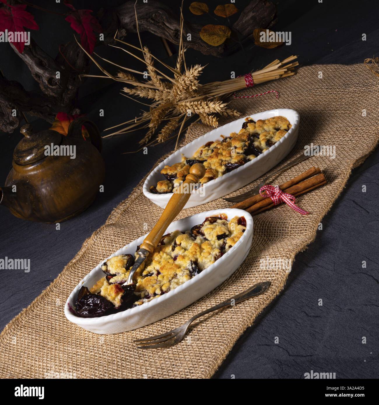 Cinnamon plums with crumble Stock Photo - Alamy