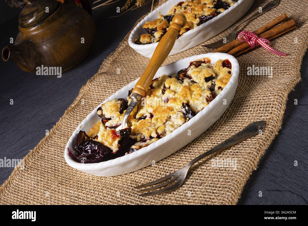 Cinnamon plums with crumble Stock Photo - Alamy