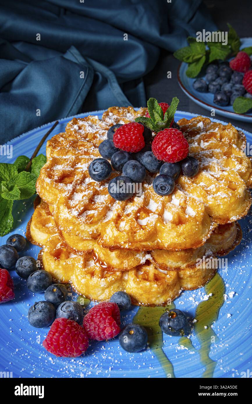 Simple sweet waffles with raspberries and blueberries Stock Photo - Alamy