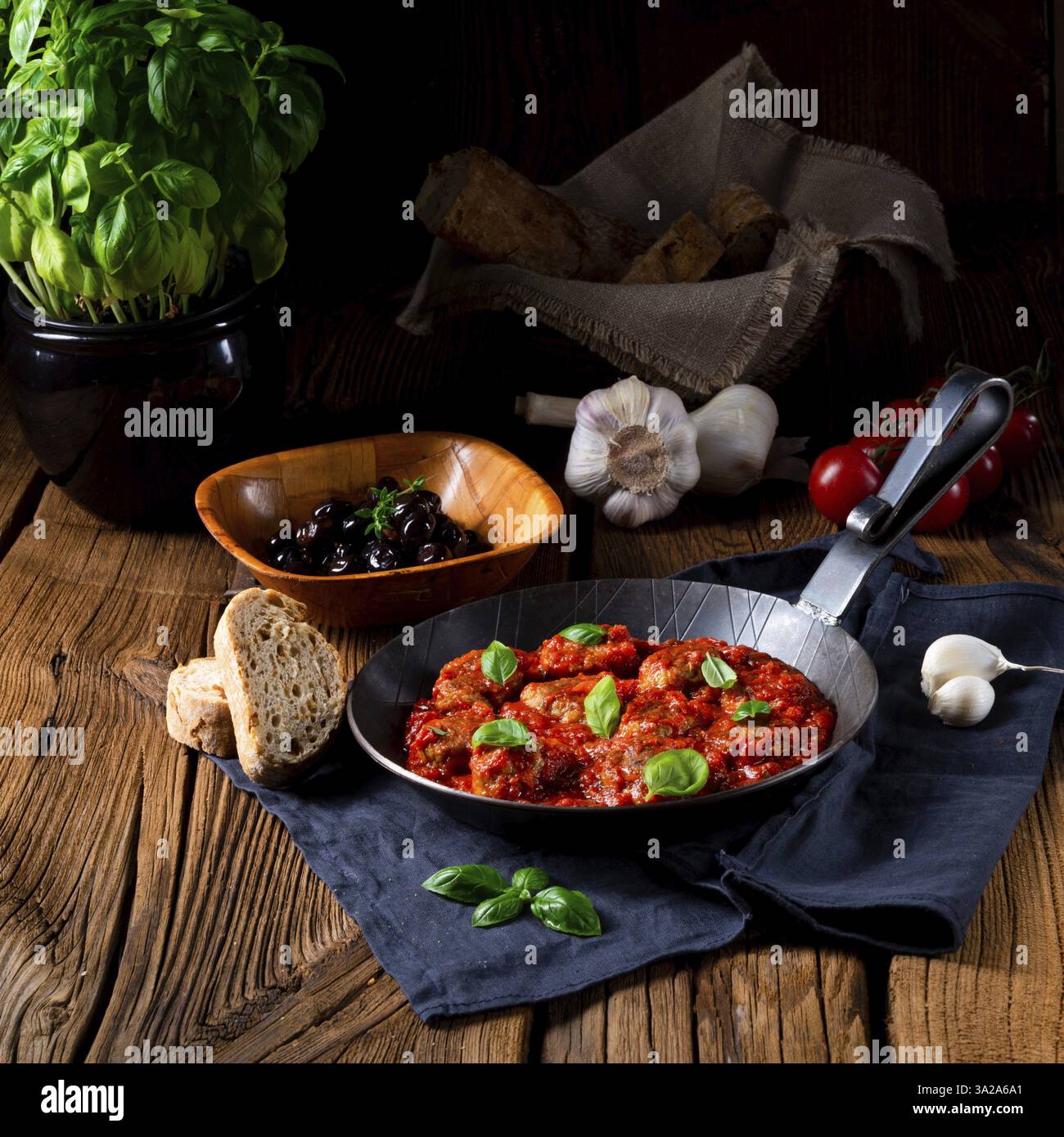 Baked mini balls in tomato sauce with basil Stock Photo - Alamy