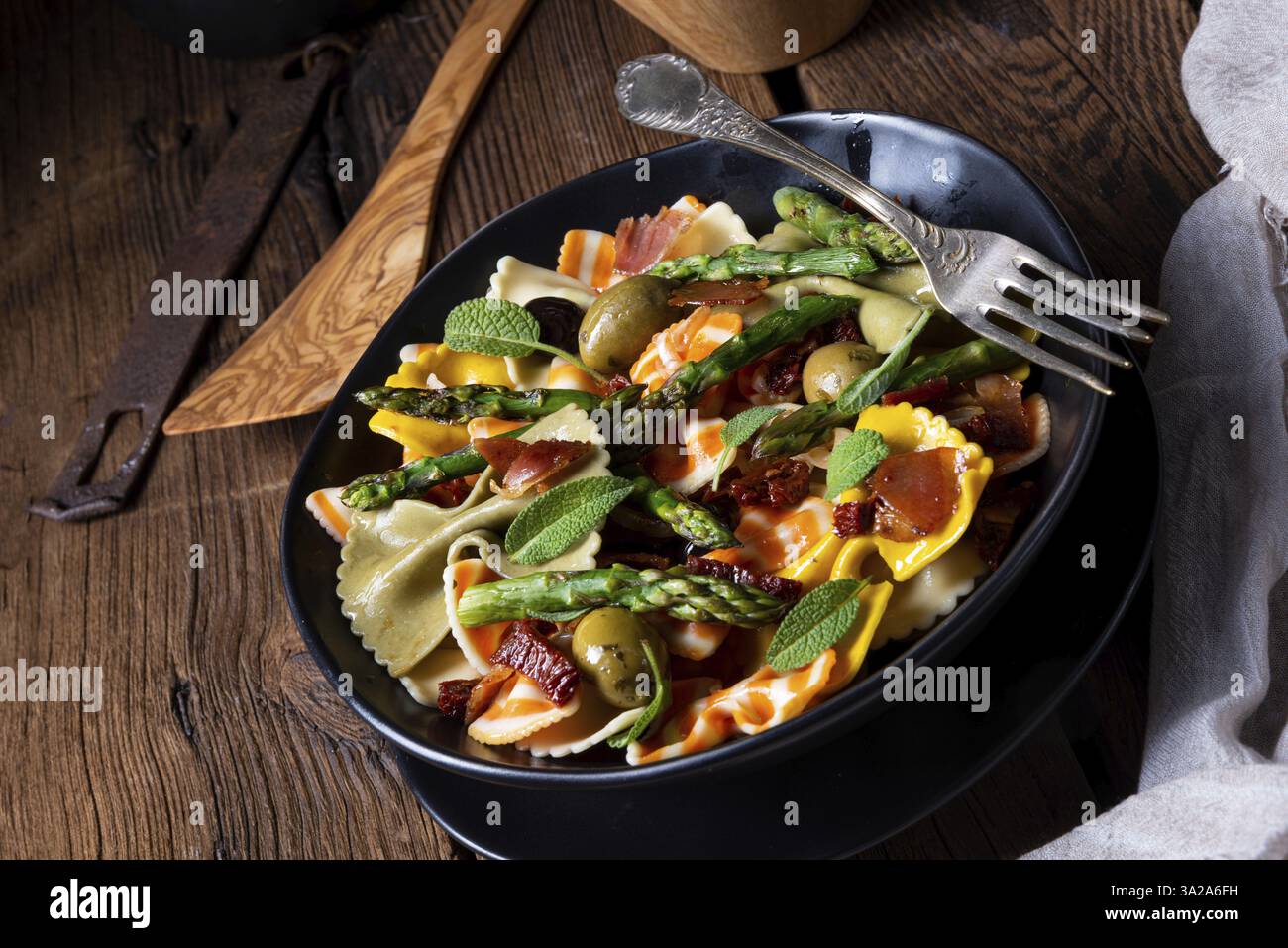 Pasta salad with green asparagus, olives and Parma ham Stock Photo - Alamy