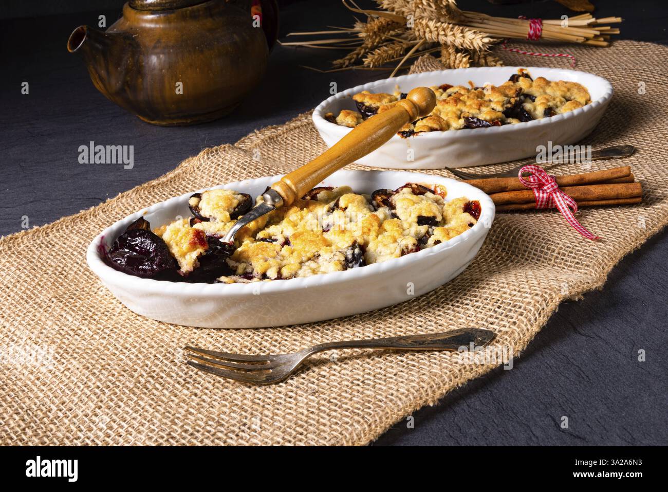 Cinnamon plums with crumble Stock Photo - Alamy