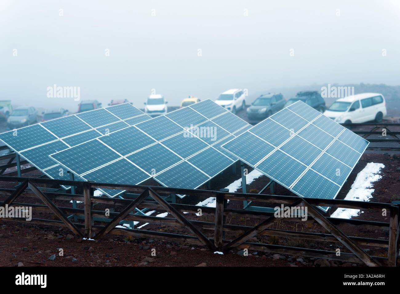 Solar energy panels capturing sunlight in a foggy mountain environment, promoting sustainable ...