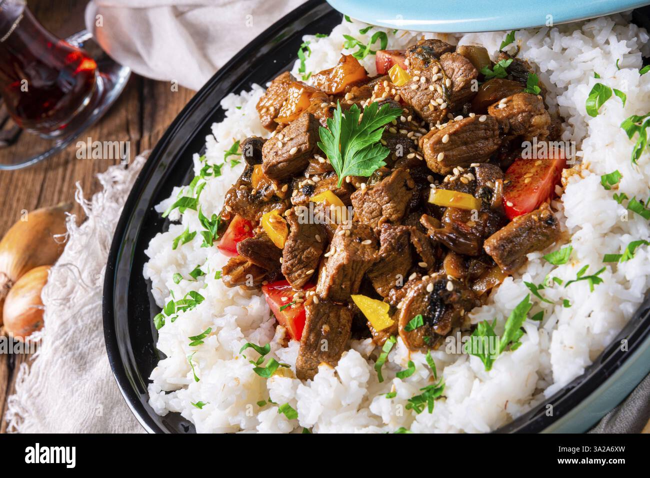 Tajin beef stew with rice, peppers and sesame seeds Stock Photo - Alamy