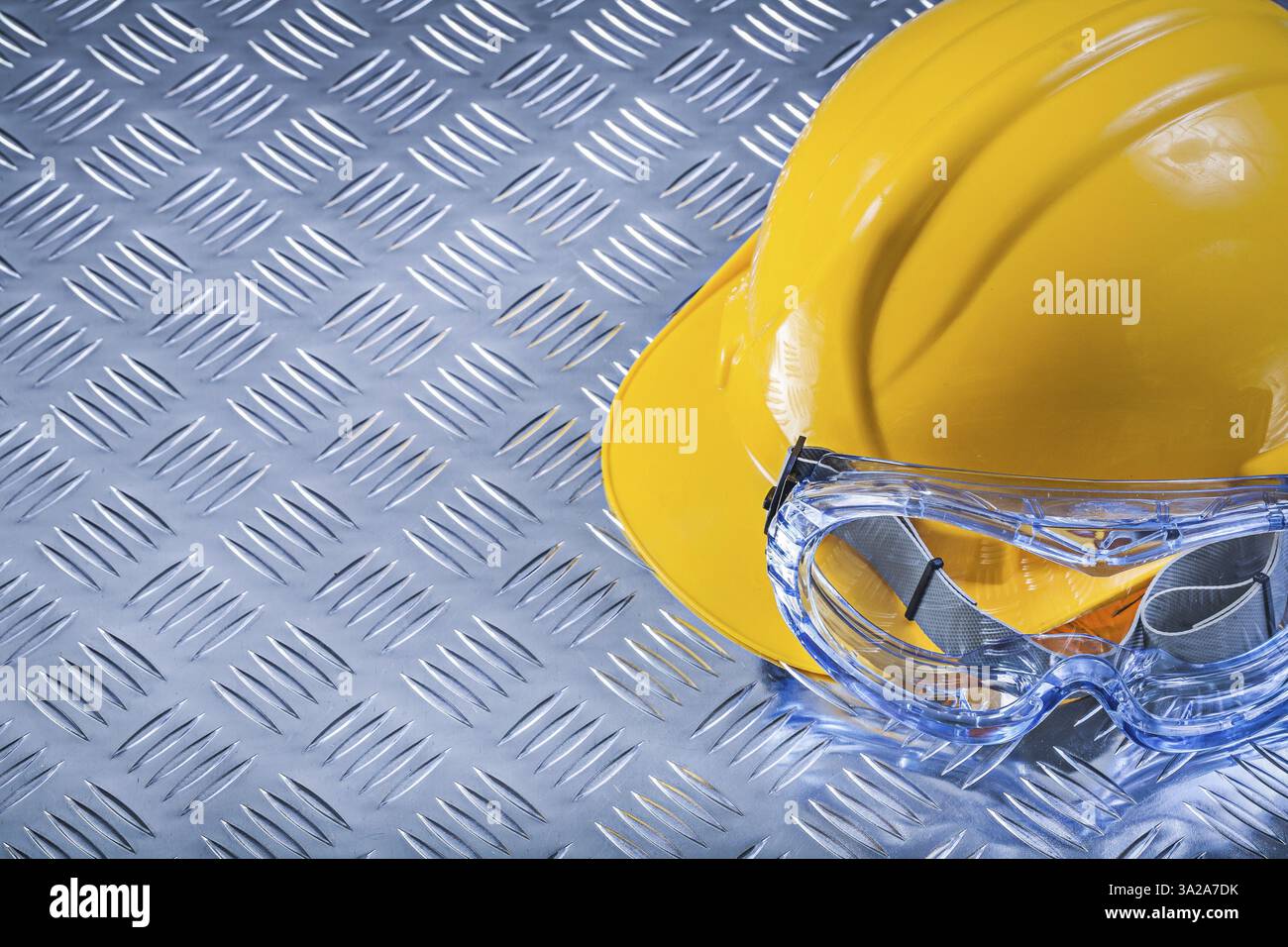 Safety spectacles building helmet on corrugated metal sheet copy space ...