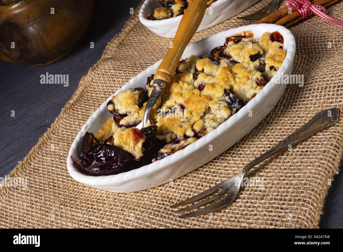Cinnamon plums with crumble Stock Photo - Alamy