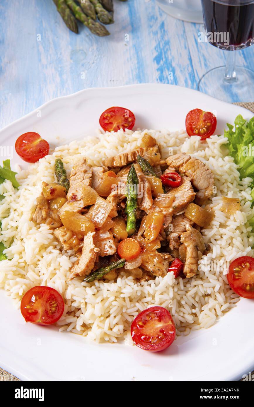 Turkey fricassee on rice with asparagus and peppers Stock Photo - Alamy