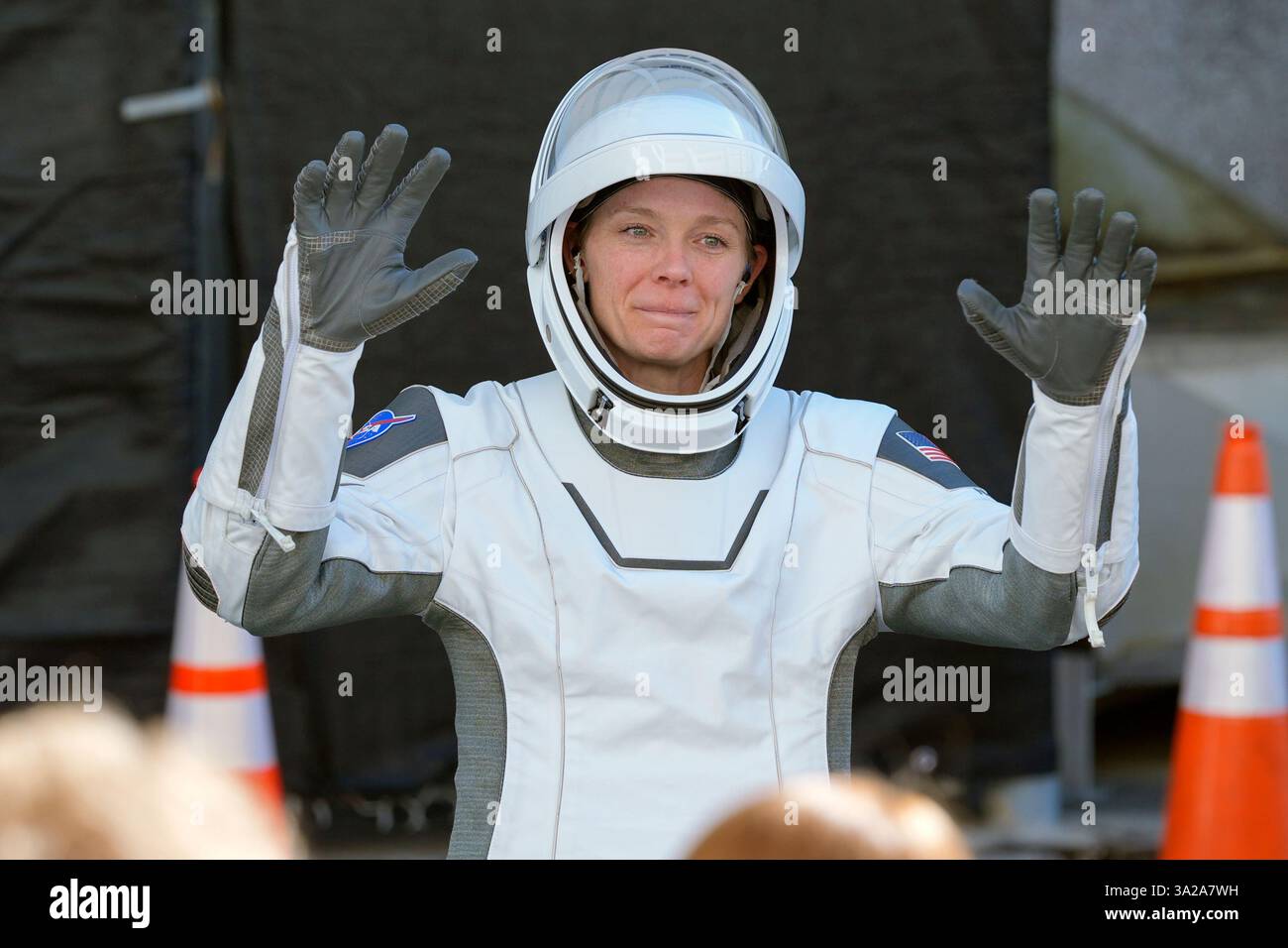 Astronaut Nichole Ayers waves as she leaves the Operations and Checkout ...