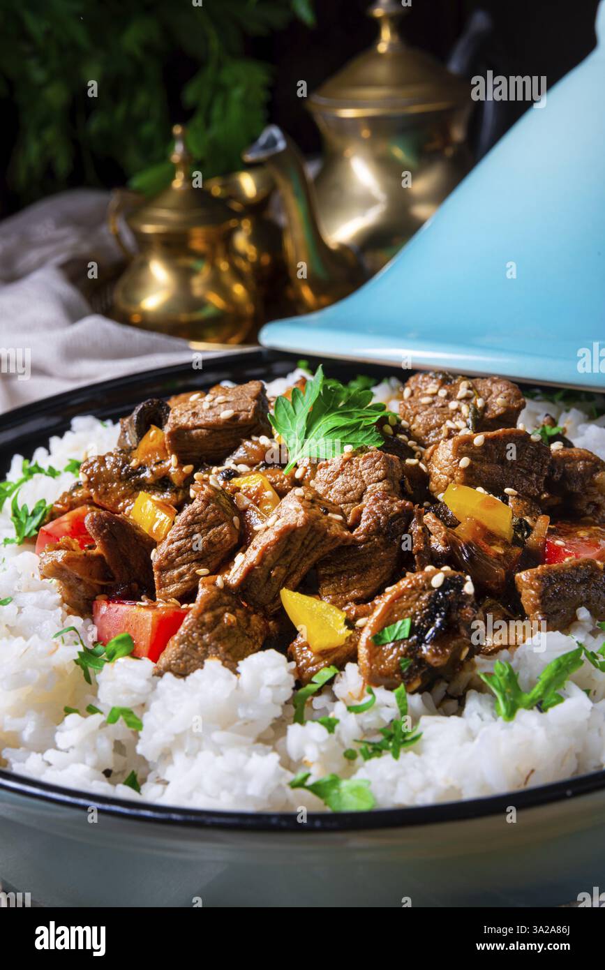 Tajin beef stew with rice, peppers and sesame seeds Stock Photo - Alamy