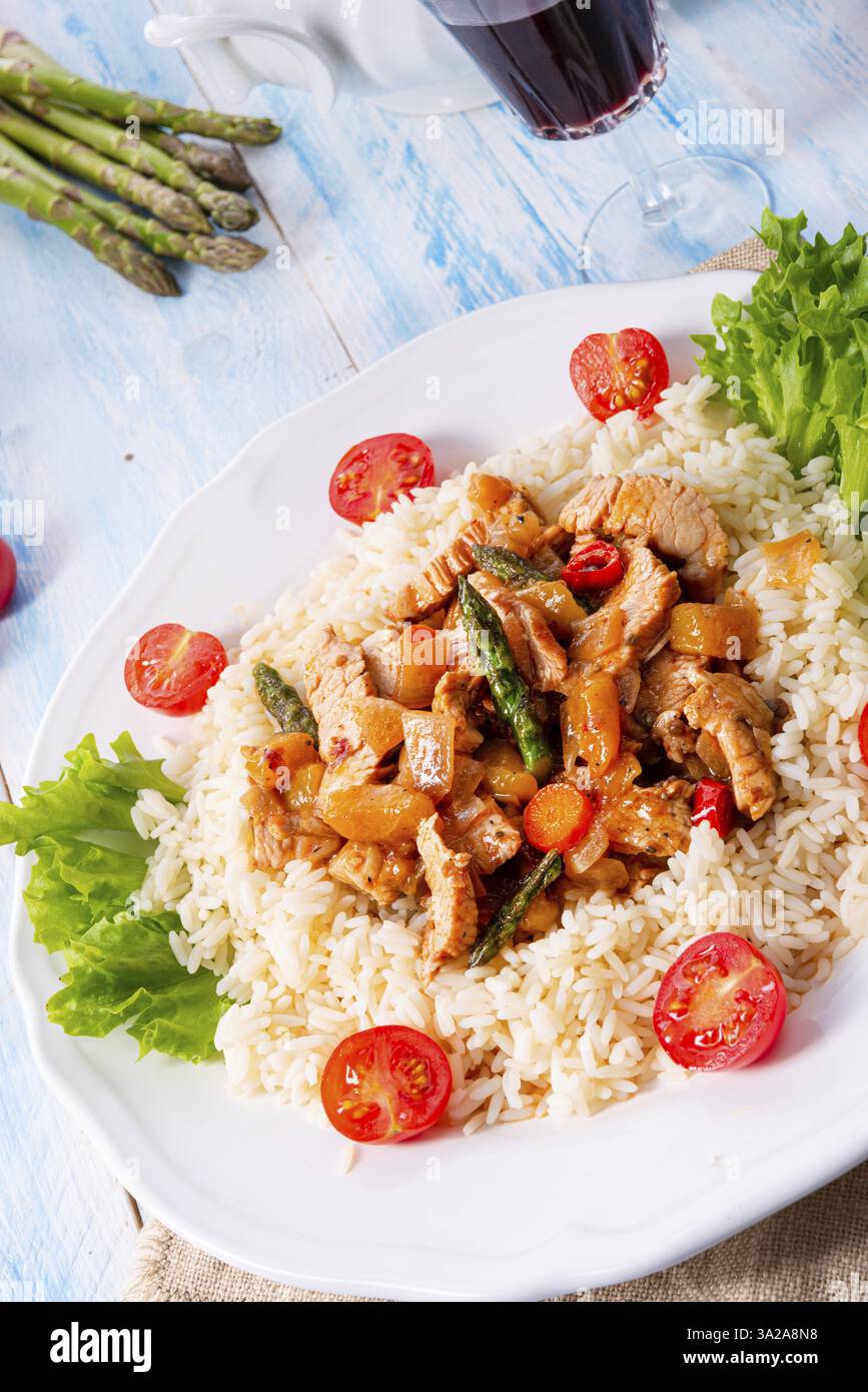 Turkey fricassee on rice with asparagus and peppers Stock Photo - Alamy