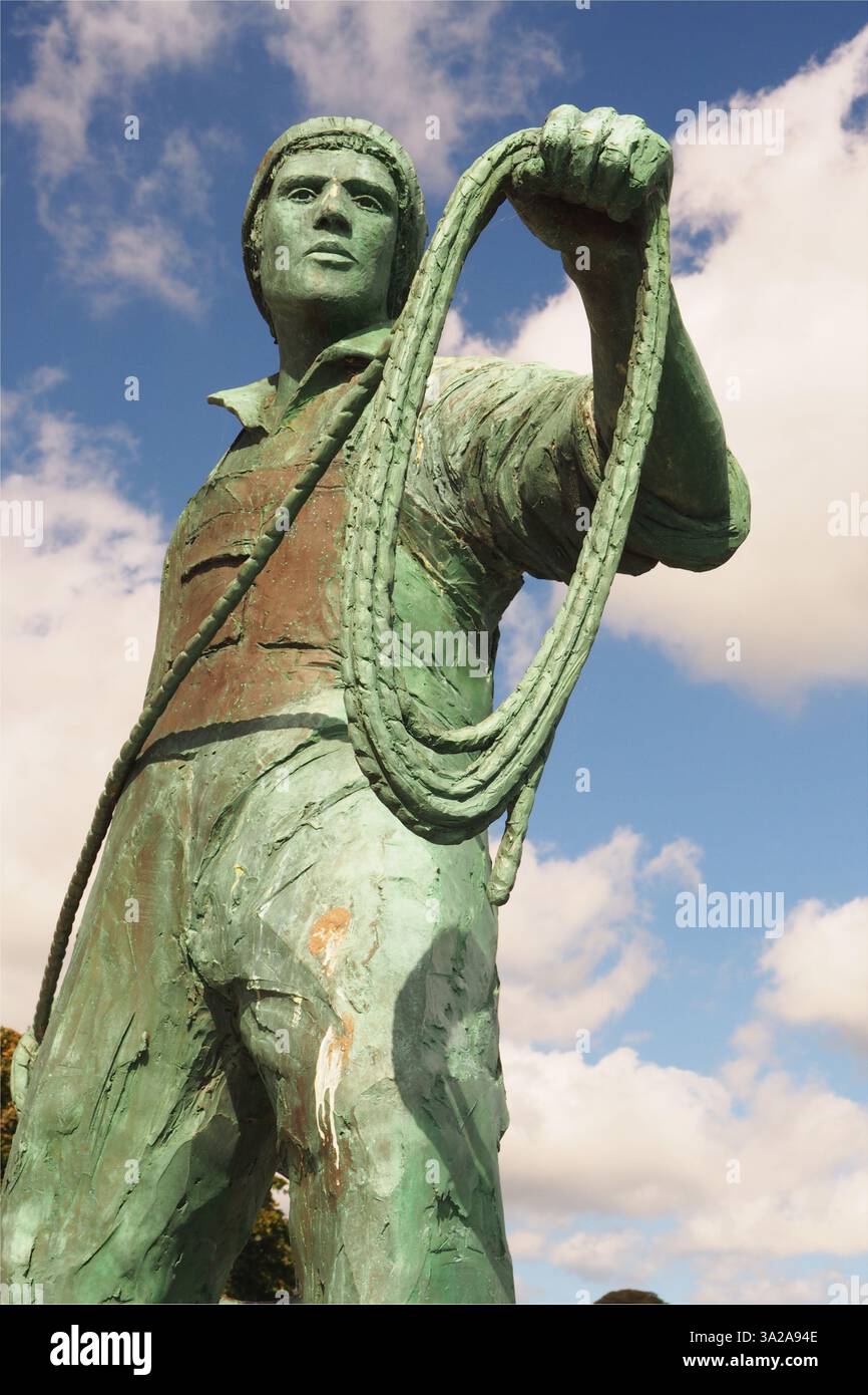 A statue of a fisherman casting a looped rope as a memorial to ...