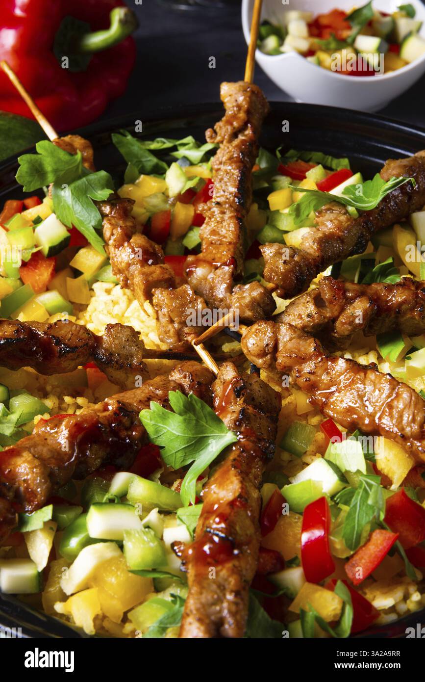 Lamb kebabs with curry rice and various vegetables Stock Photo - Alamy