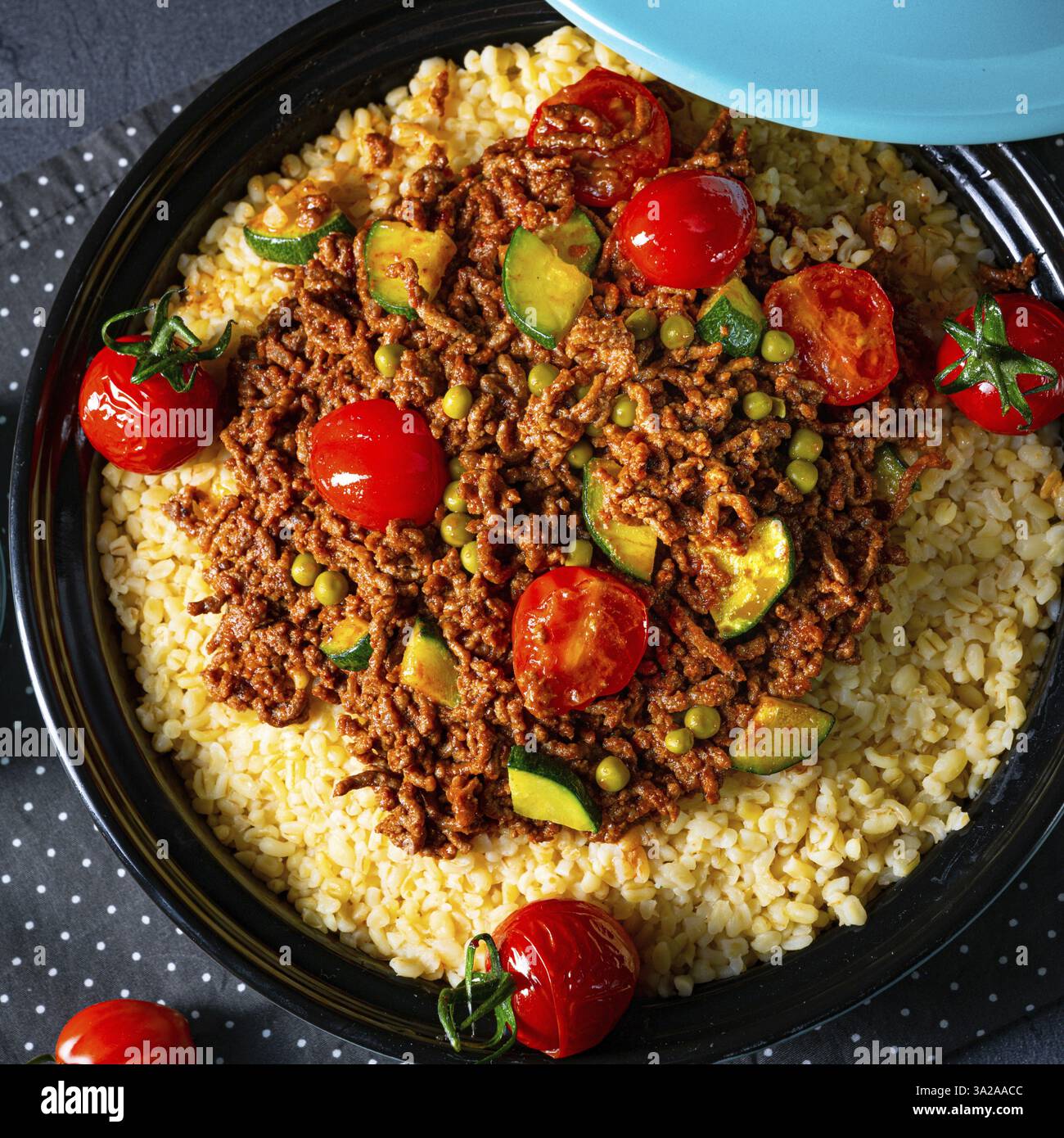 Tomato bulgur with vegetables and minced meat Stock Photo - Alamy