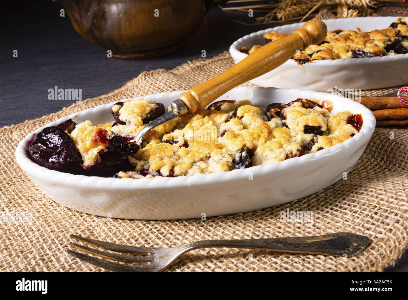 Cinnamon plums with crumble Stock Photo - Alamy