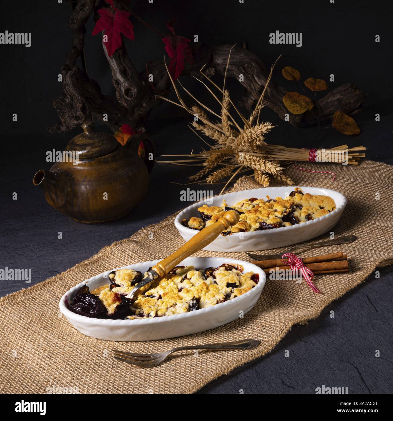 Cinnamon plums with crumble Stock Photo - Alamy