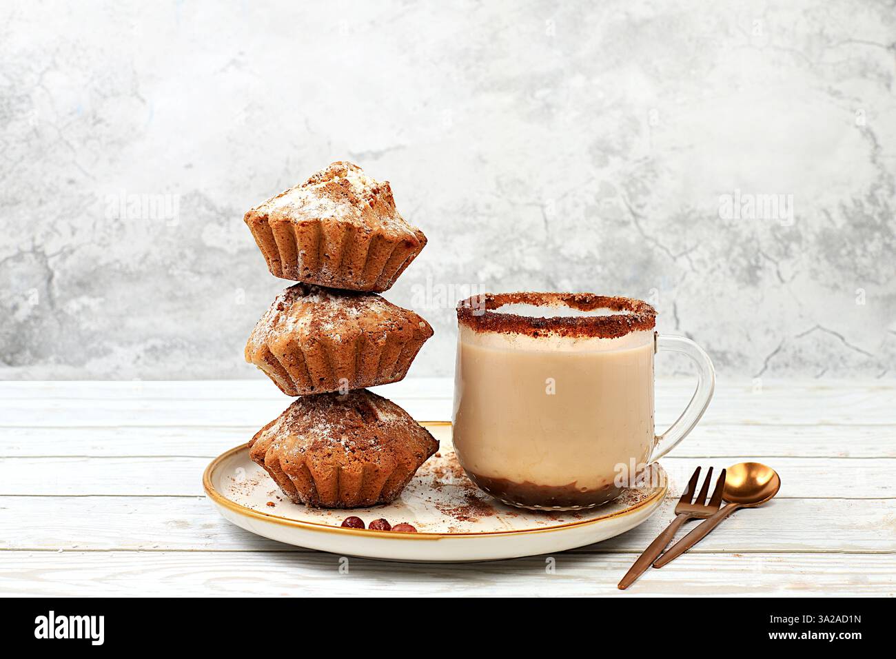 Chocolate muffins with nutmeg and cinnamon eggnog on a concrete ...