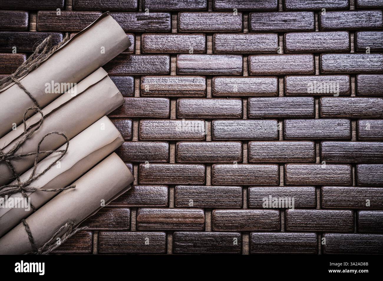 Rolled vintage documents on wicker wooden matting copyspace Stock Photo ...