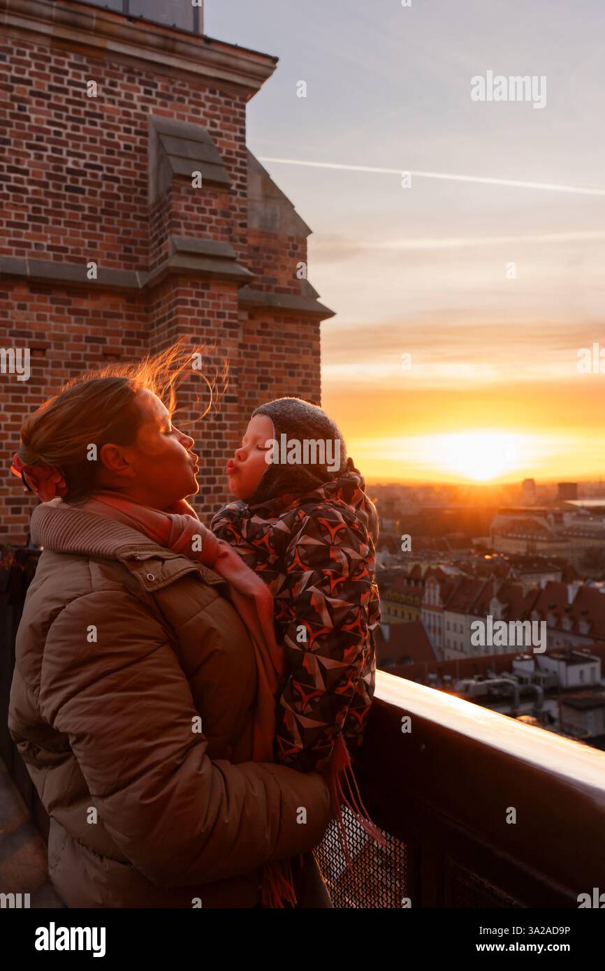 Tender moment between mother and her child on scenic city viewpoint at ...