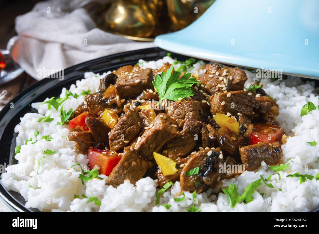 Tajin beef stew with rice, peppers and sesame seeds Stock Photo - Alamy