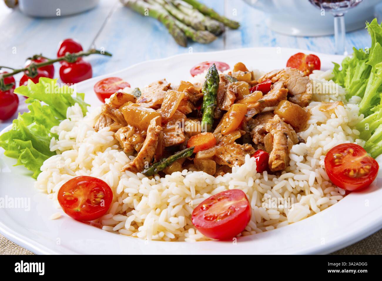Turkey fricassee on rice with asparagus and peppers Stock Photo - Alamy