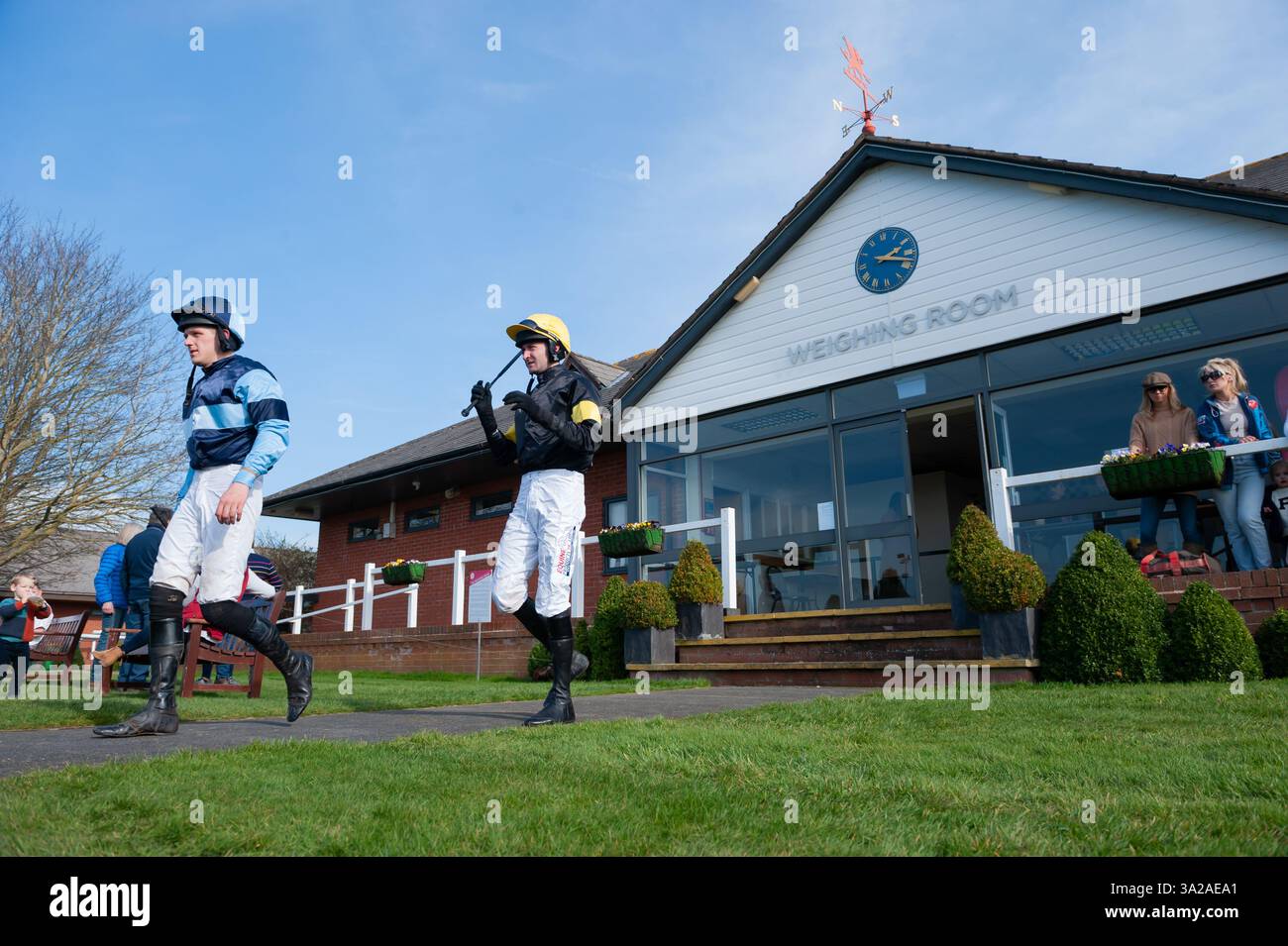 Jockeys Mr Huw Edwards and Mr Tommie O' leave the weighing room at Bangor-On-Dee Racecourse ...