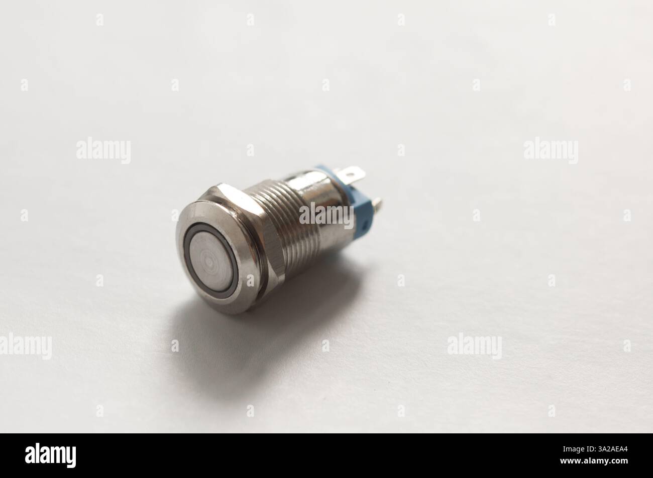 Power button with circular backlight, silver isolation button on white ...