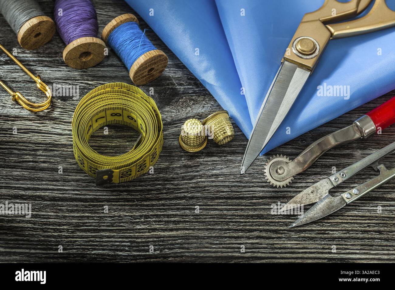 Sewing tools composition measure tape thimbles threads scissors on ...