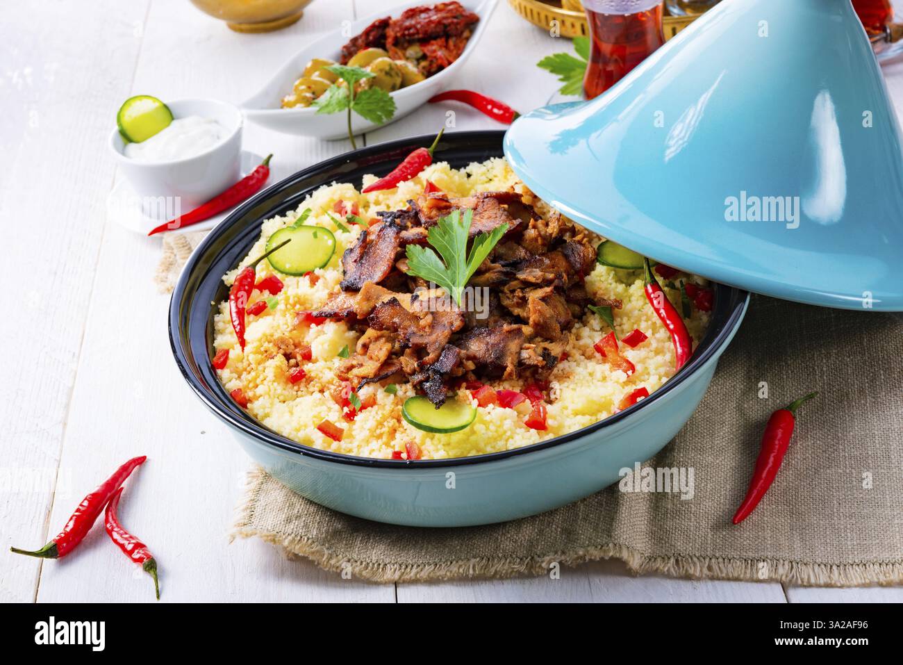 Tajin with couscous, vegetables and meat on a white background Stock ...
