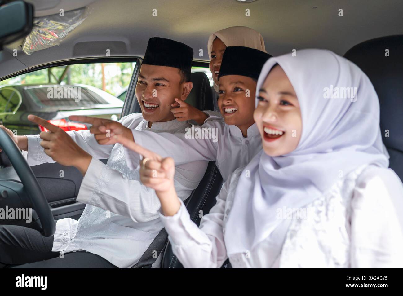 An Indonesian Muslim family is going mudik or traveling to their ...
