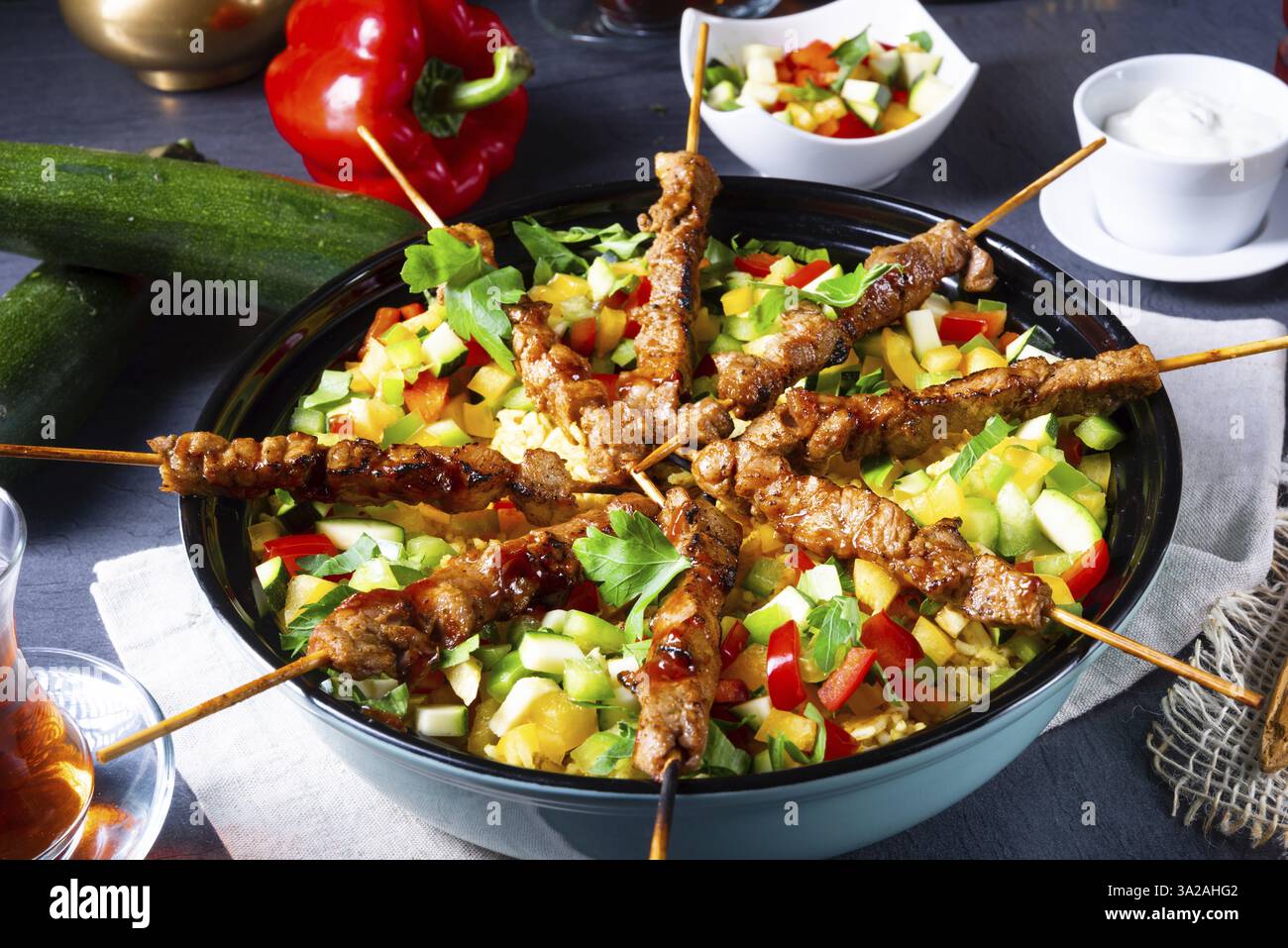 Lamb kebabs with curry rice and various vegetables Stock Photo - Alamy