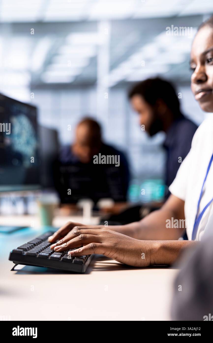 Programmer in server room using artificial intelligence technology for increased productivity in ...