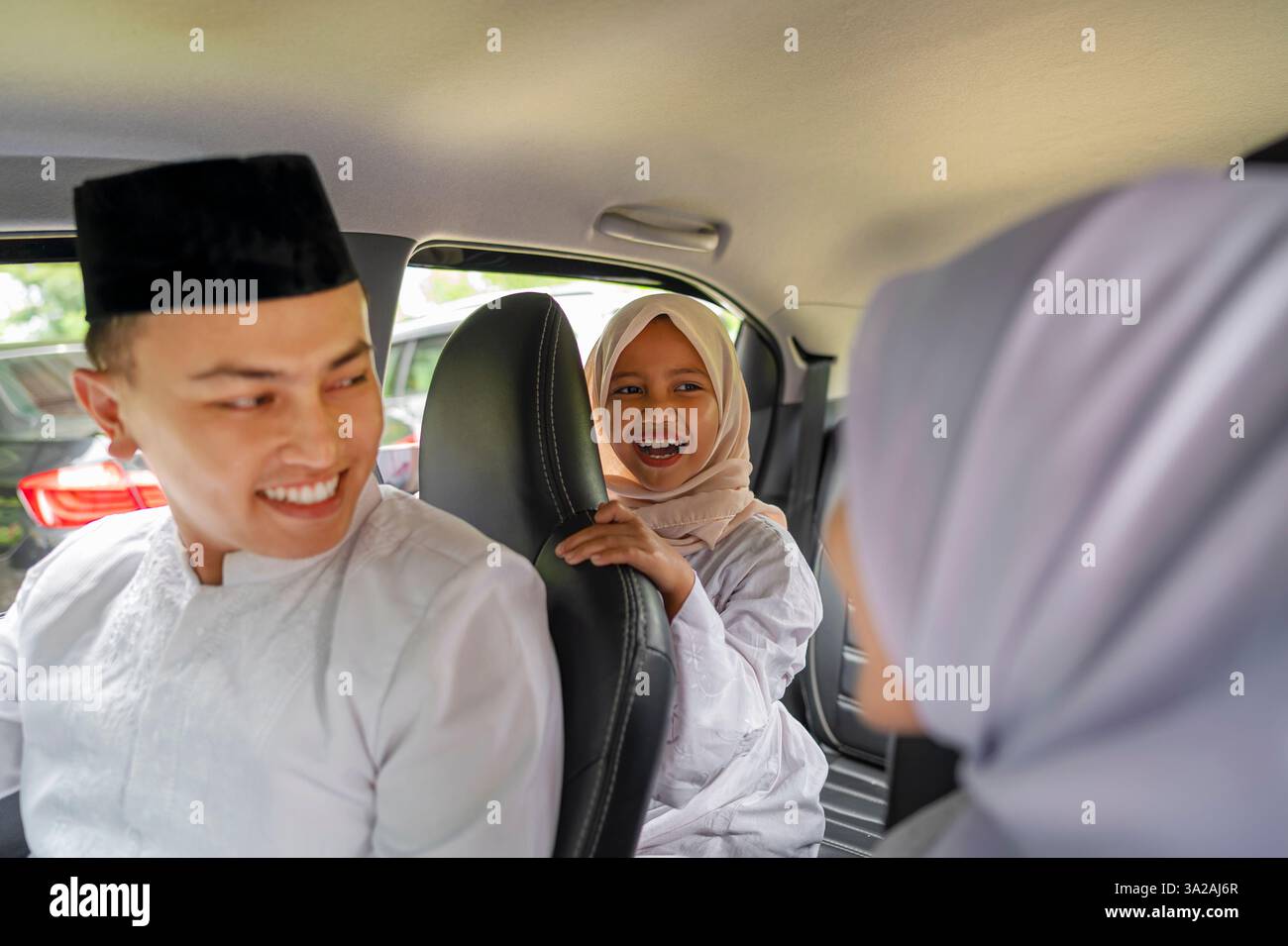 An Indonesian Muslim family is going mudik or traveling to their ...