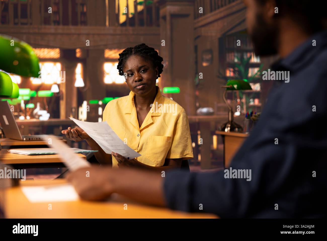 African american team comparing class notes and doing research at the ...