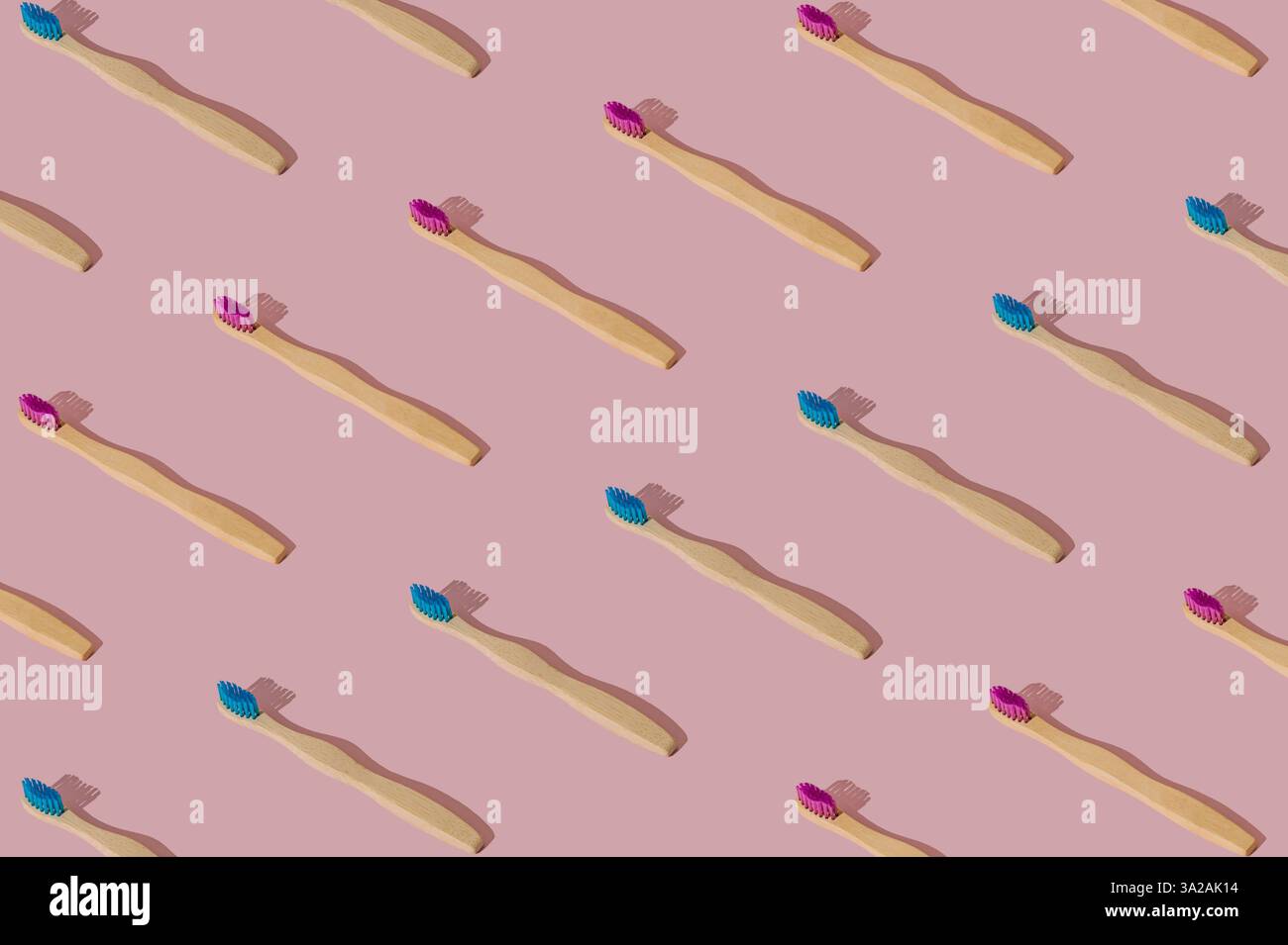 Organic bamboo toothbrush pattern composition on pastel pink background ...