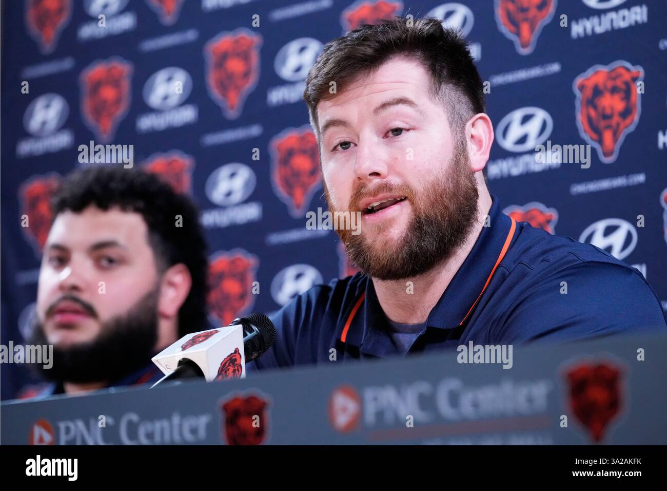 Chicago Bears football guard Joe Thuney, right, talks to media as Jonah ...